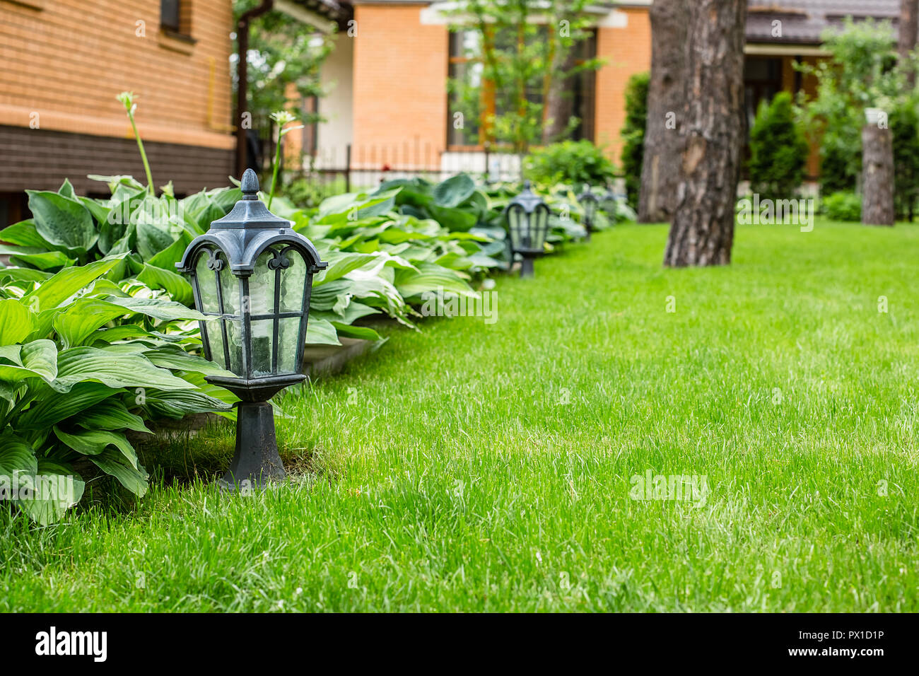 Garden lantern on the green grass. landscape design Stock Photo - Alamy