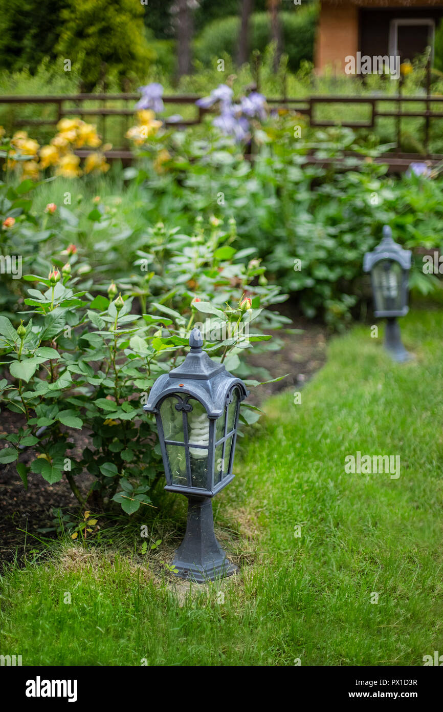Garden lantern on the green grass. landscape design Stock Photo - Alamy