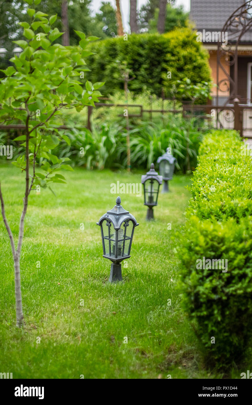 Garden lantern on the green grass. landscape design Stock Photo - Alamy