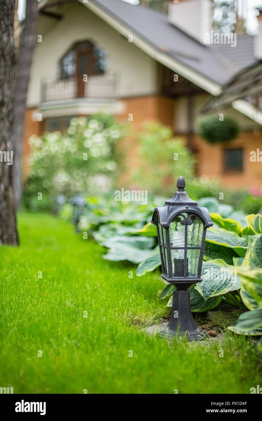 Garden lantern on the green grass. landscape design Stock Photo - Alamy