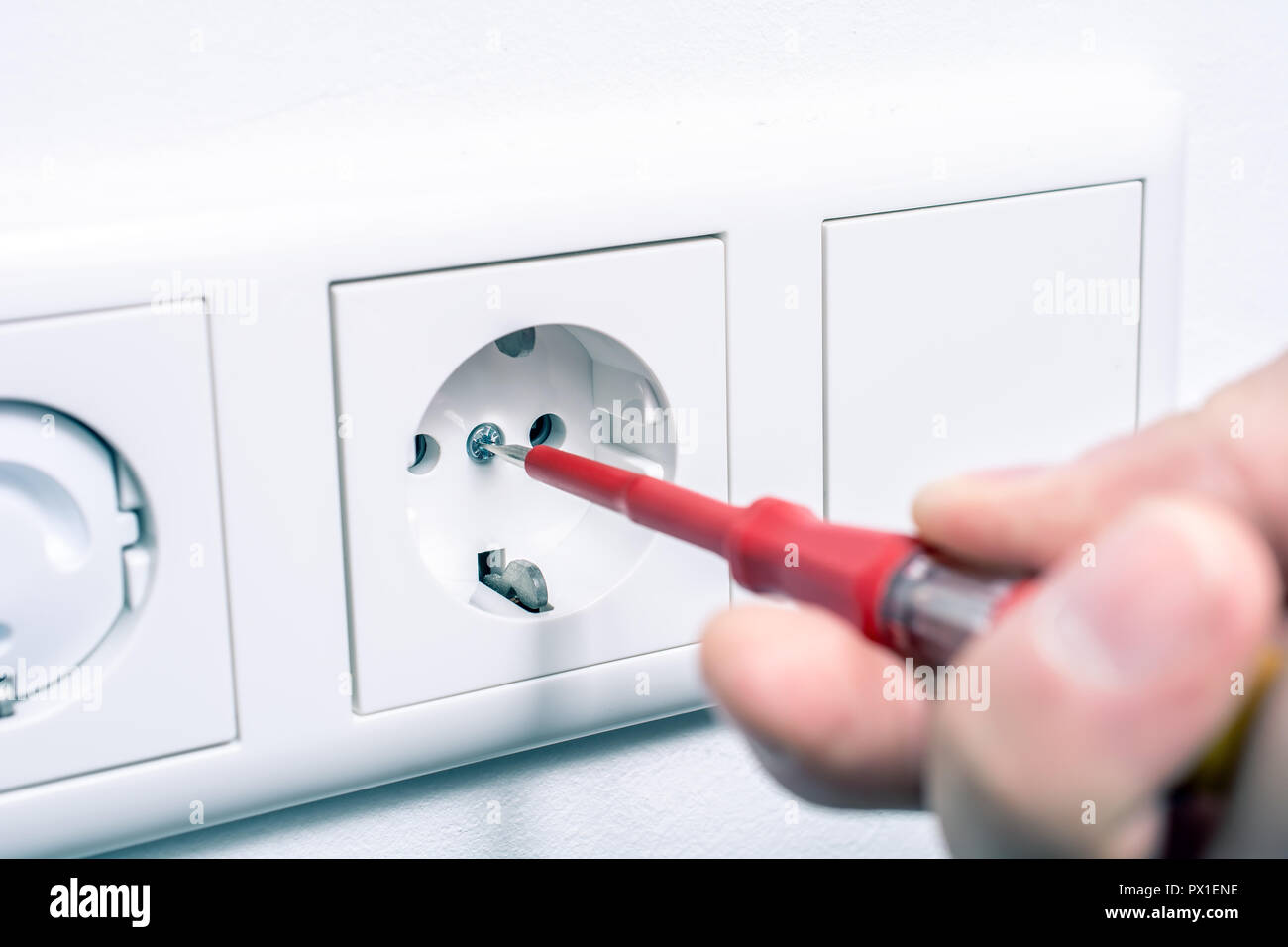Hand Of An Electrician Using A Phase Tester Screwdriver To Repair A ...