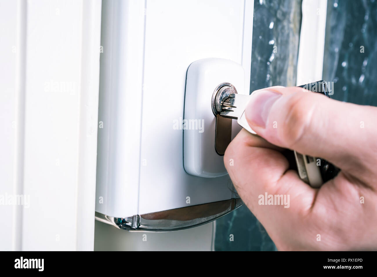Male Hand Using A Key With A Security Door Lock, Prevent Burglary ...