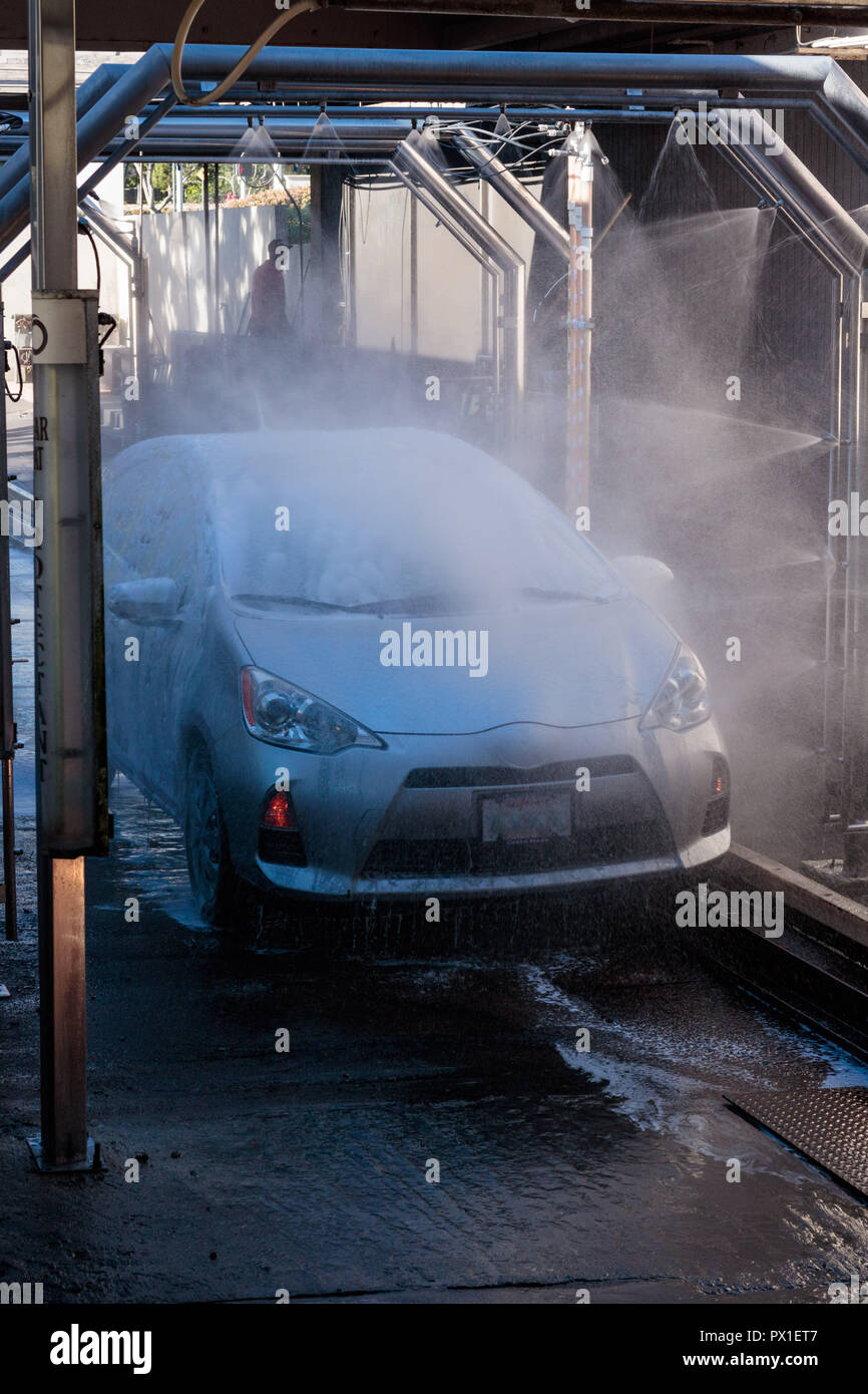 Car being spray washed in an automated car wash, vertical format Stock ...