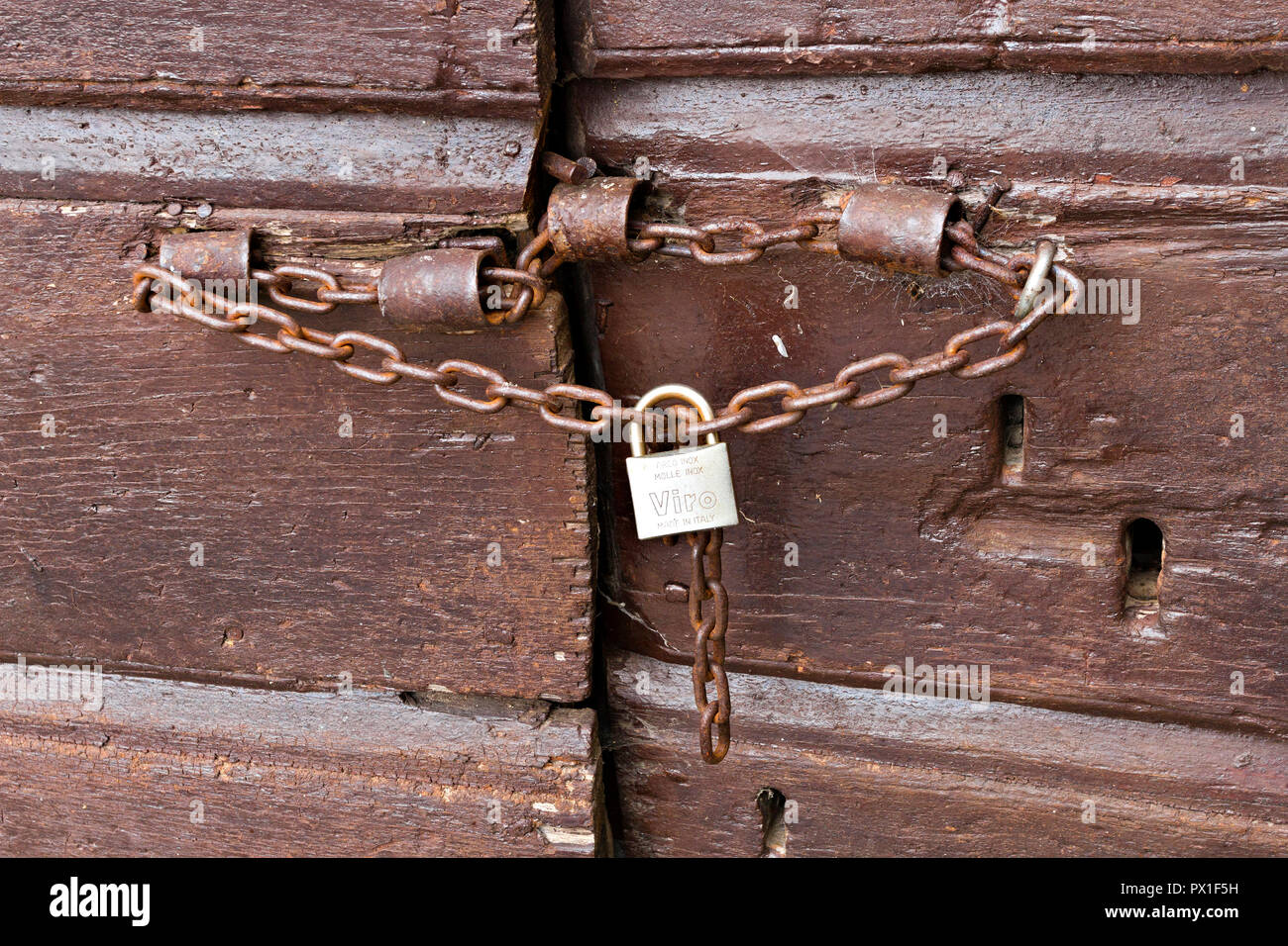 Lock and Chain on a old wooden door, Sorano, Province of Grosseto ...