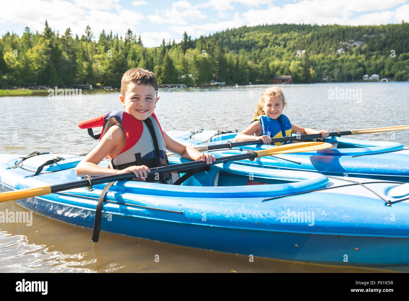 Summer vacation Portrait of cute boy and girl kayaking the on river ...