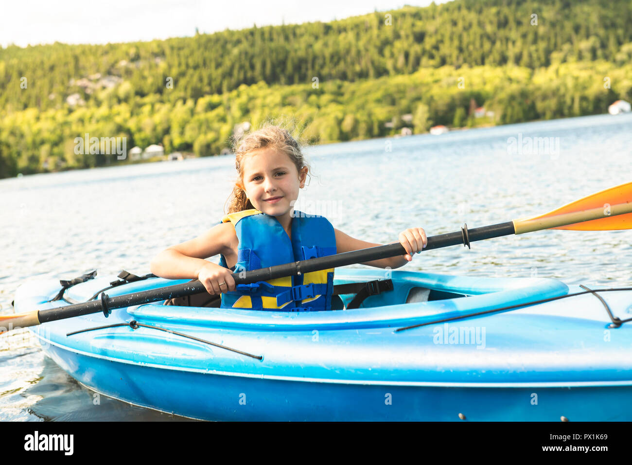 Summer vacation Portrait of happy cute girl kayaking the on river Stock ...