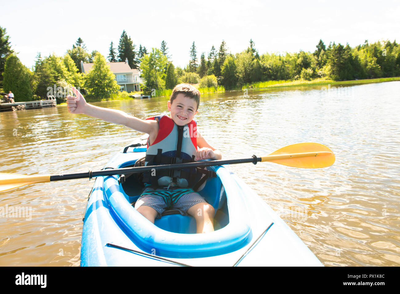 Summer vacation Portrait of happy cute boy kayaking the on river Stock ...