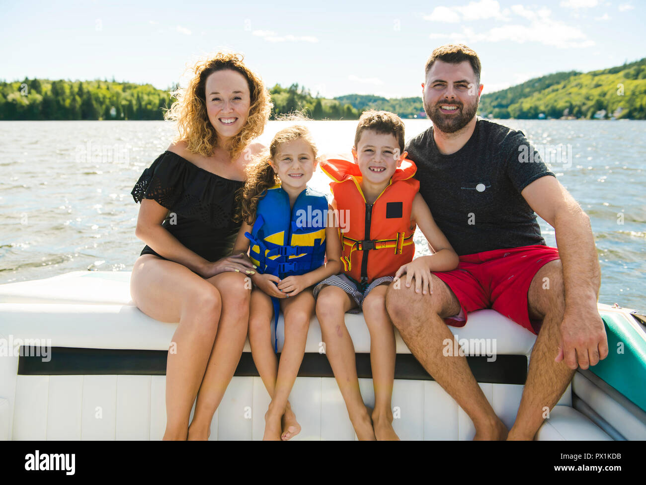Family out boating together having fun on vacancy Stock Photo - Alamy
