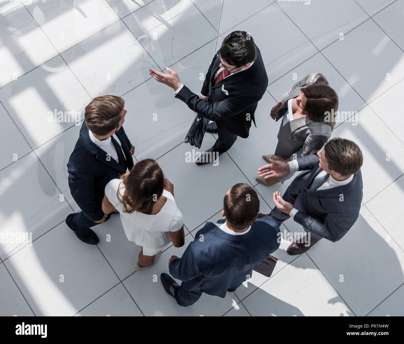 top view. employees standing in a modern office Stock Photo - Alamy
