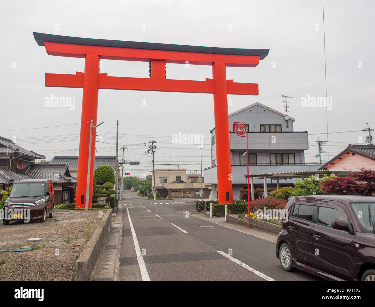 Torii gate, urban street, houses and cars, Ishizuchi jinja, Saijo ...