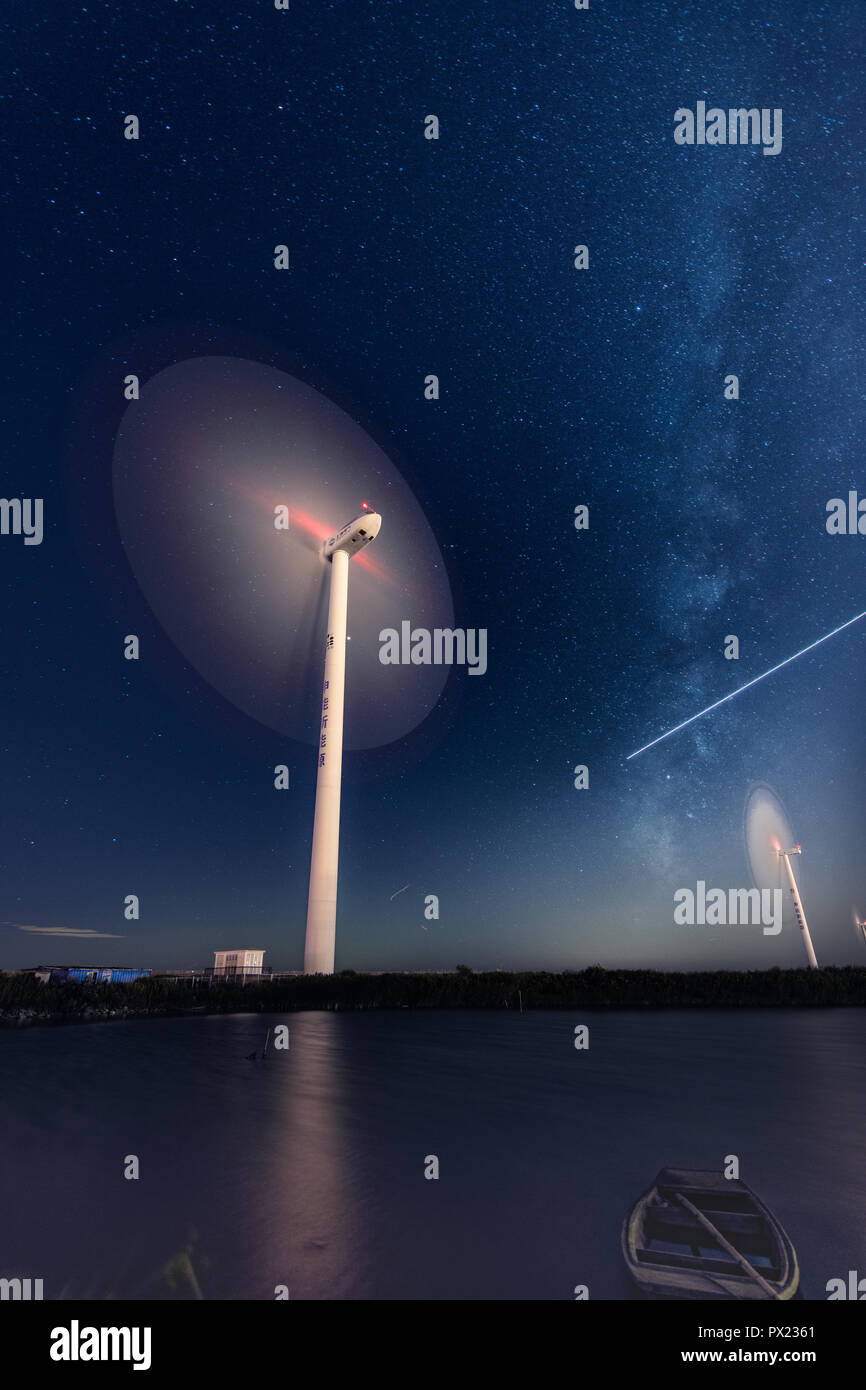 Wind power against the starry night with the shooting star Stock Photo ...