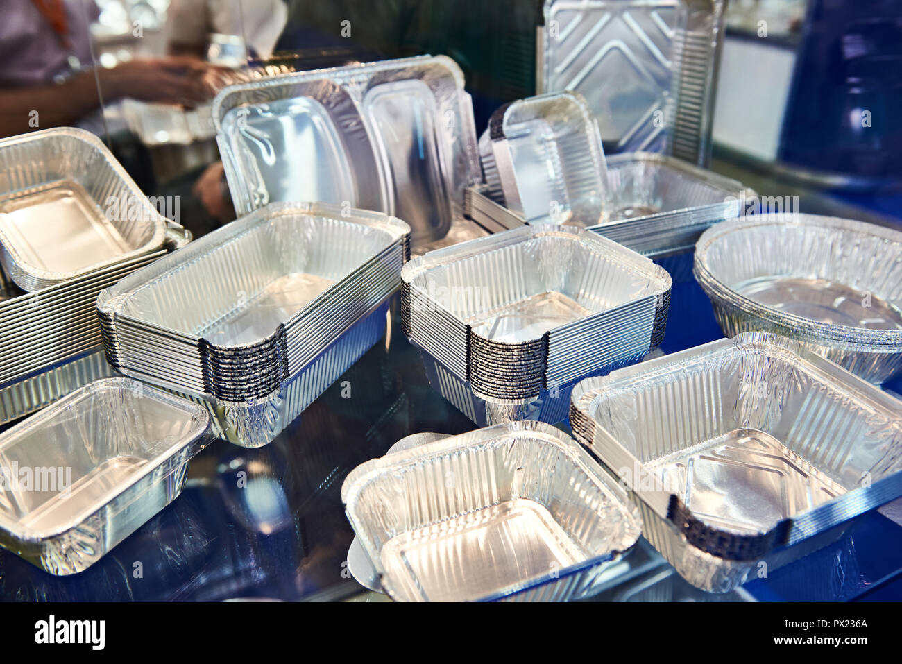Forms for baking from metal foil in the shop window Stock Photo - Alamy