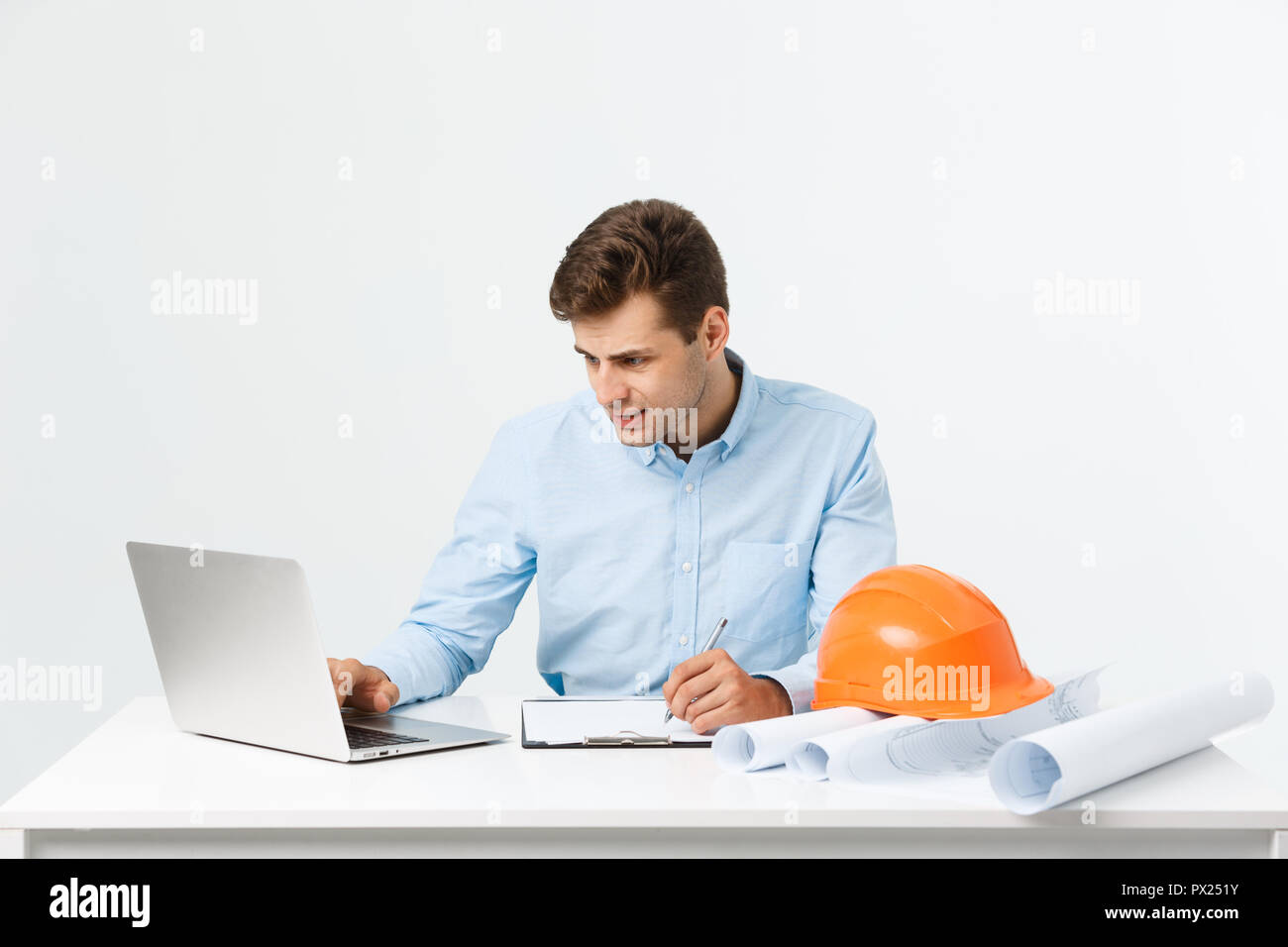 Portrait of confused male designer or architect, feels stressed, being ...