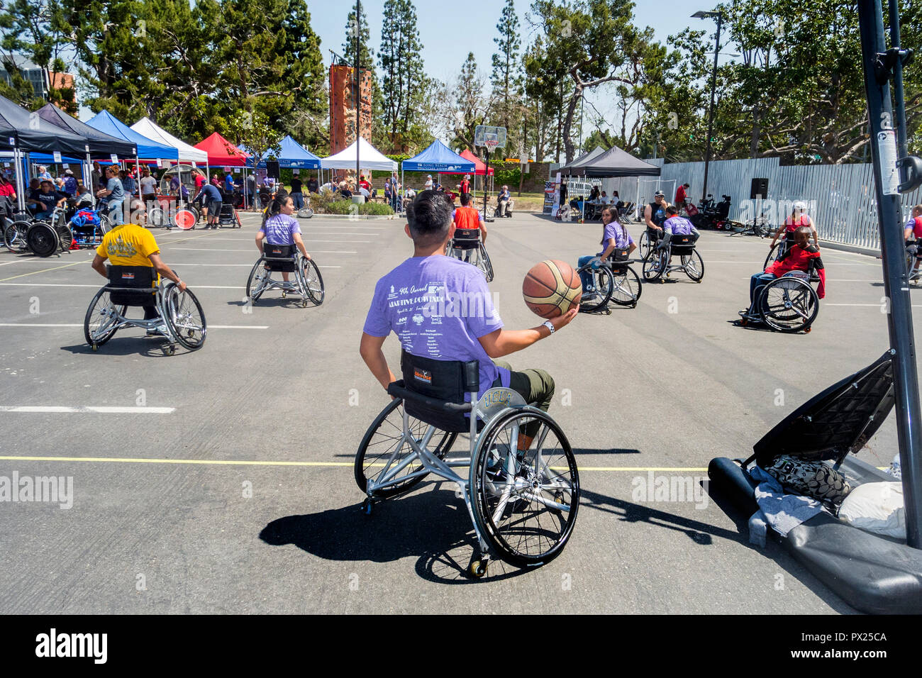 Multiracial handicapped members of a wheelchair basketball team play a ...