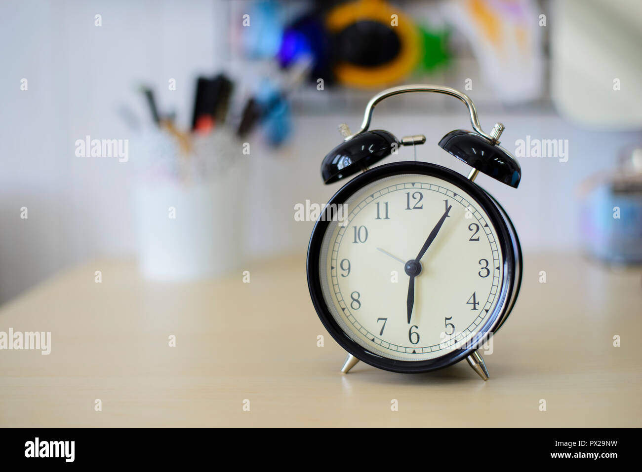 Black alarm clock on the table Stock Photo - Alamy