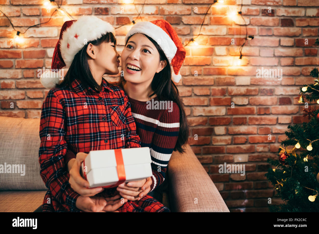 Merry Christmas and Happy Holidays! a cheerful mom surprising her kid ...