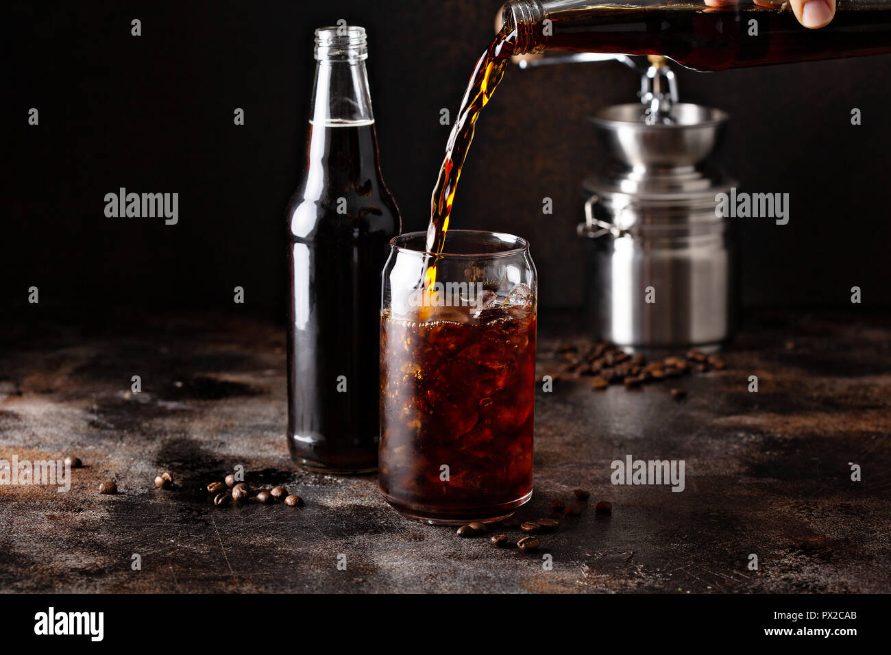Cold brew iced coffee in glass bottles being poured over ice Stock ...