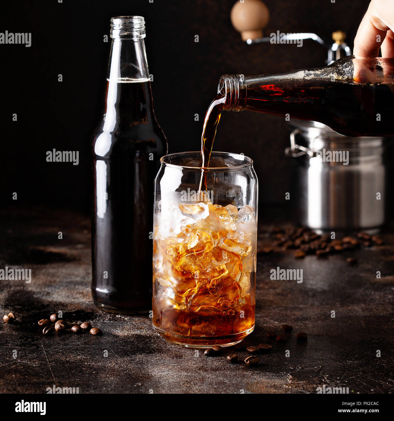 Cold brew iced coffee in glass bottles being poured over ice Stock ...
