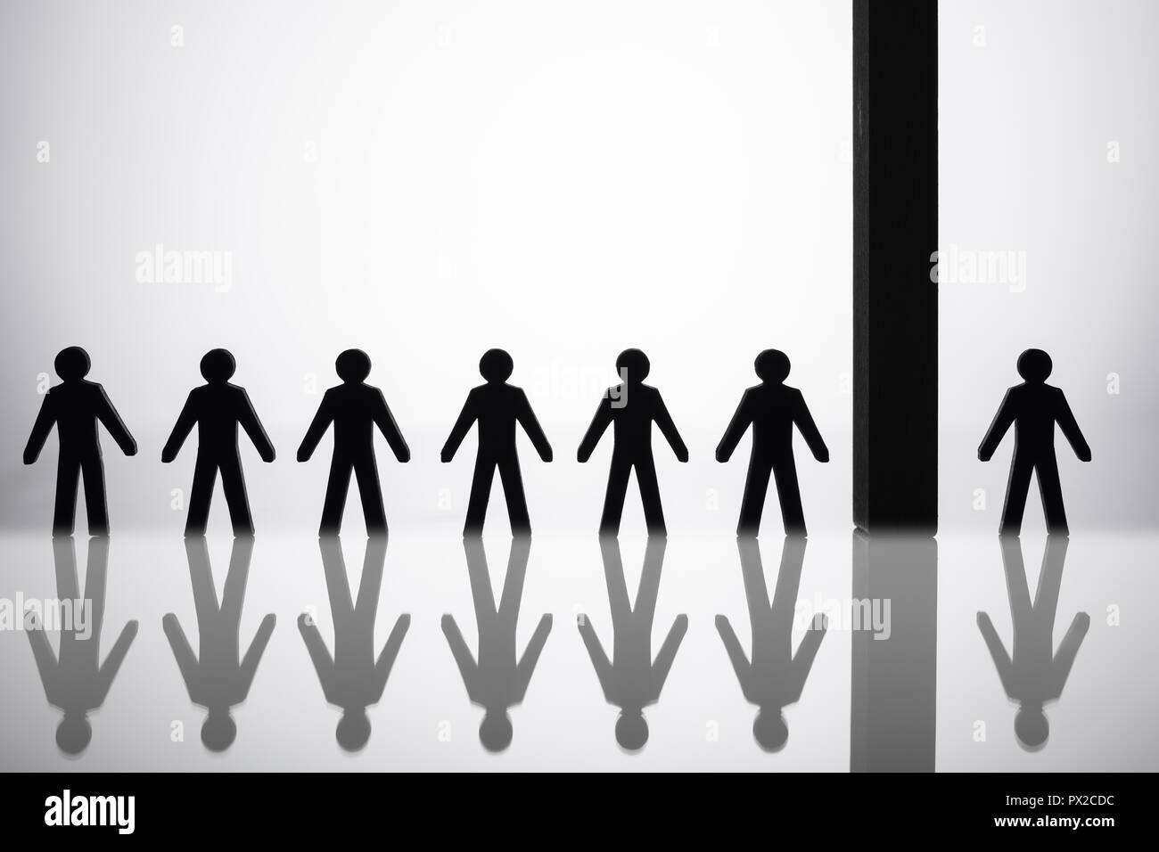 Human Figure Separated By Block From Others Standing In A Row Stock ...