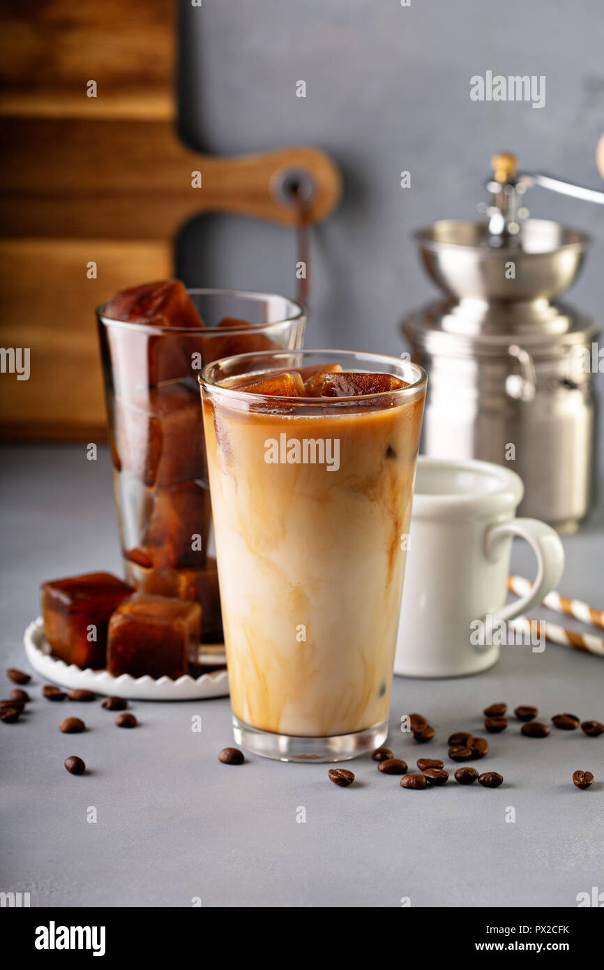 Iced coffee in tall glasses made with coffe ice cubes Stock Photo - Alamy
