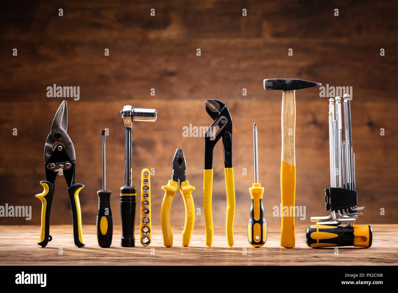 Row Of Various Worktools On Wooden Desk Stock Photo - Alamy