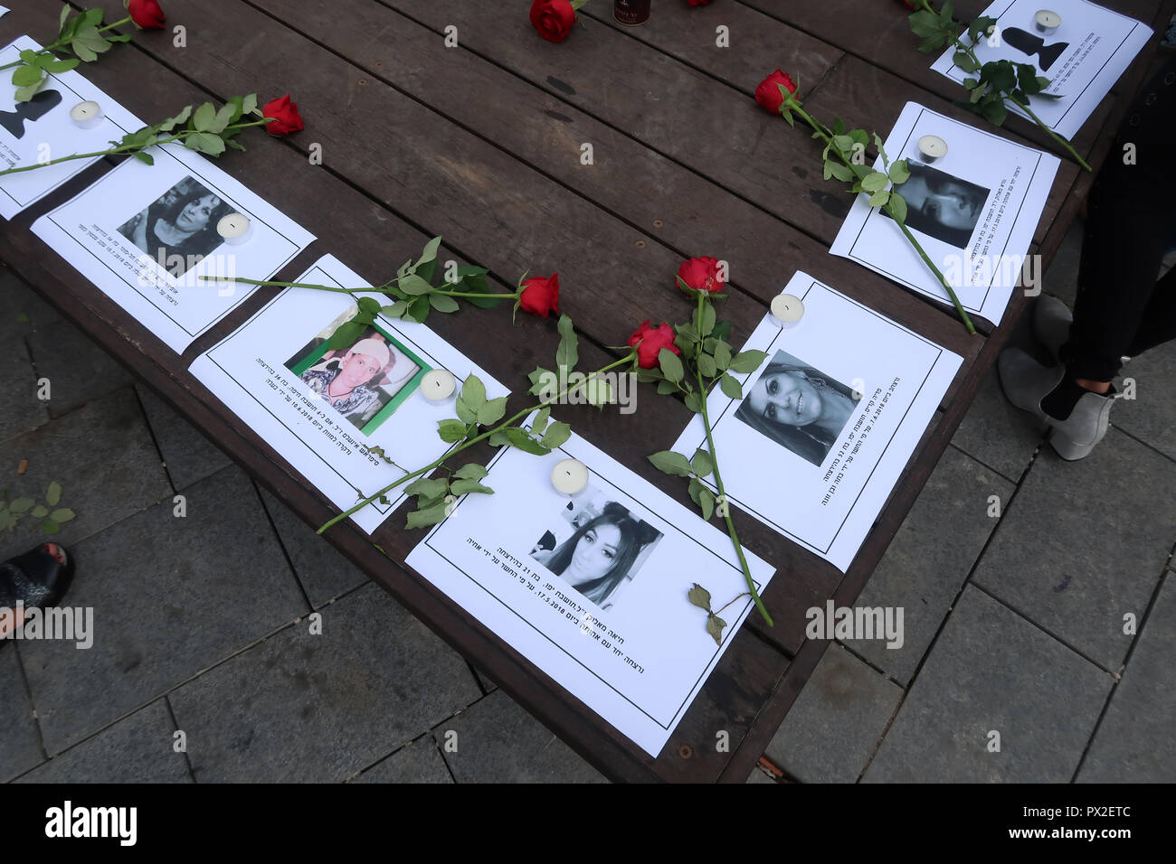 Papers with photographs and names of female homicide victims lay in ...