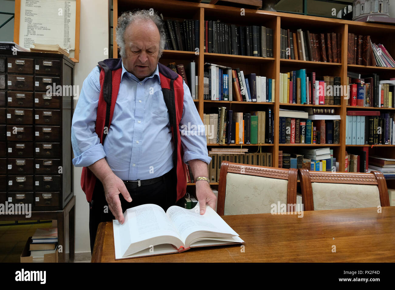 George Hintlian member of the Armenian community of Jerusalem reading a ...