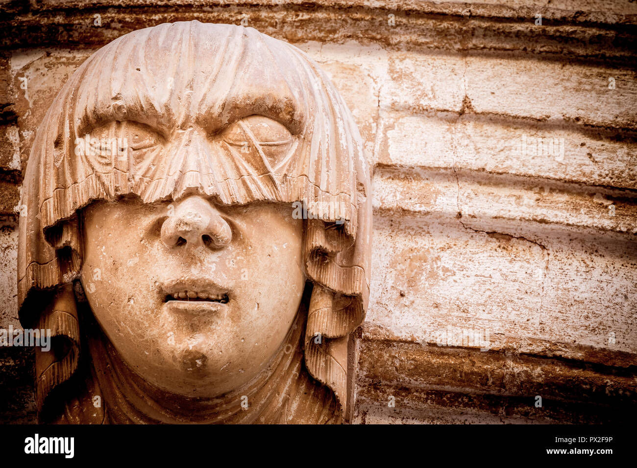 Gothic detail. Young woman portrait at the entrance of a 200 years old ...