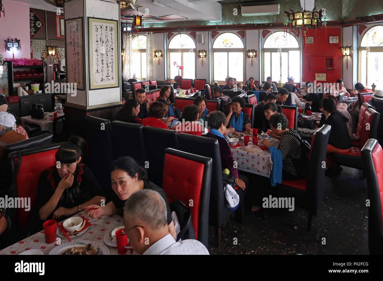 A group of Chinese tourists eating in the Chinese Mandarin Restaurant ...