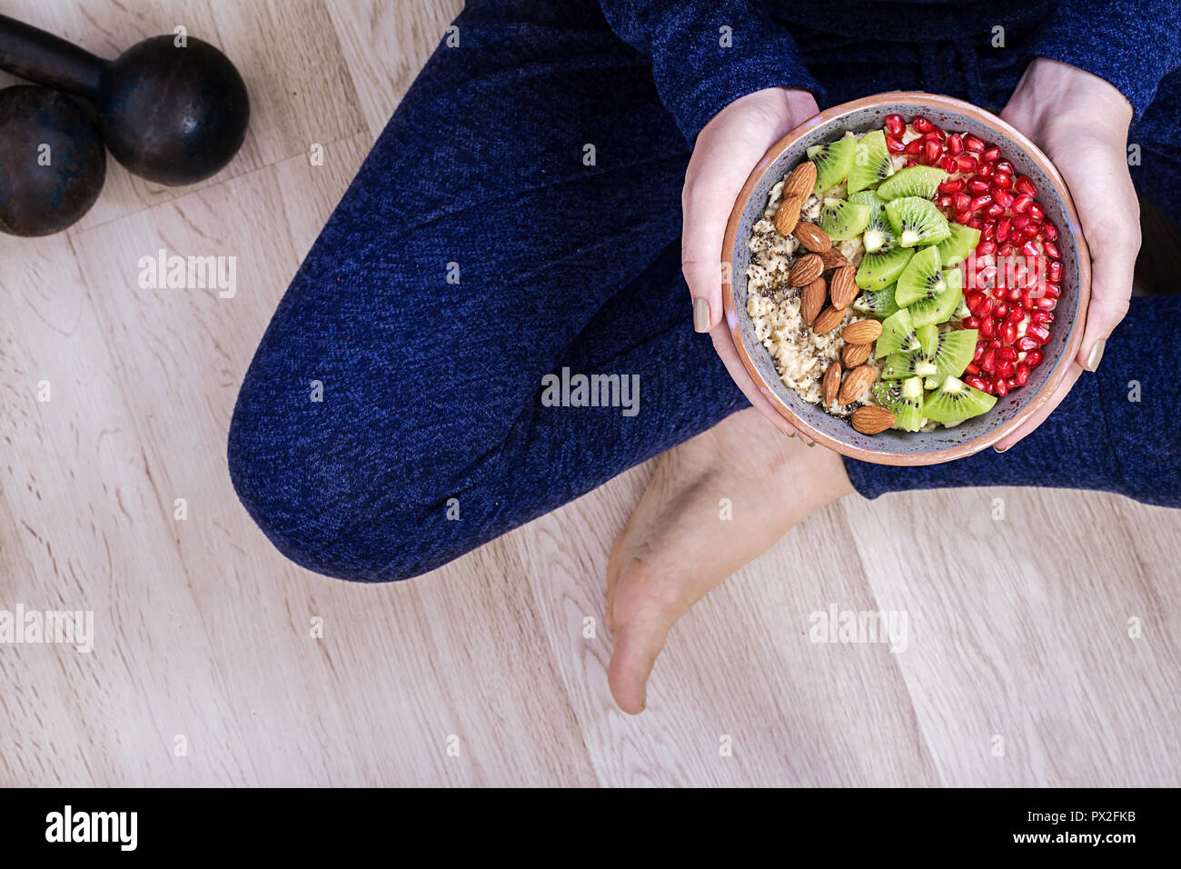 Fitness and healthy lifestyle concept. Female is resting and eating a ...