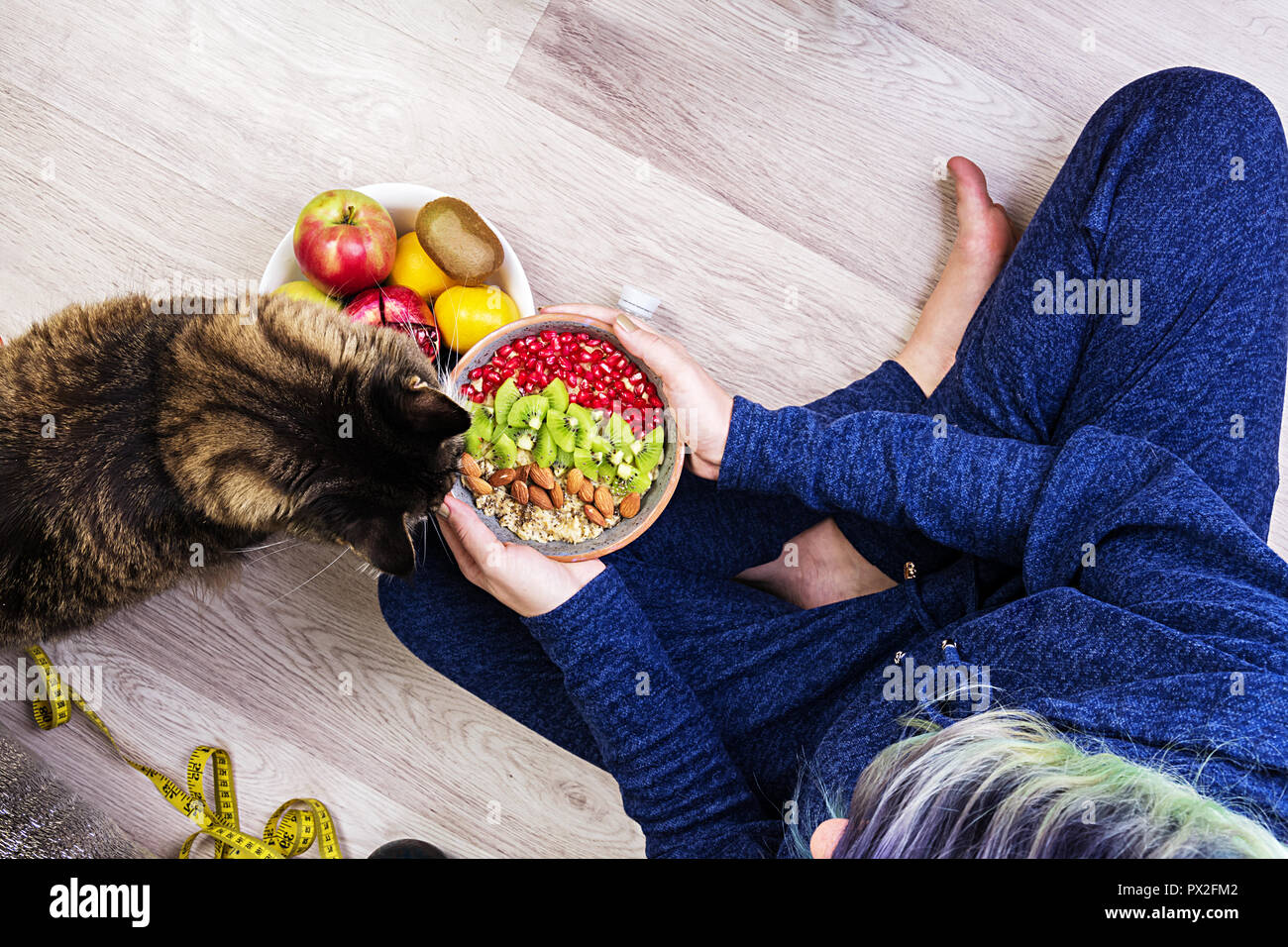 Fitness and healthy lifestyle concept. Female is resting and eating a ...