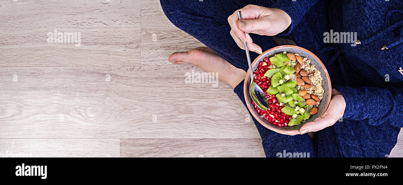 Fitness and healthy lifestyle concept. Female is resting and eating a ...