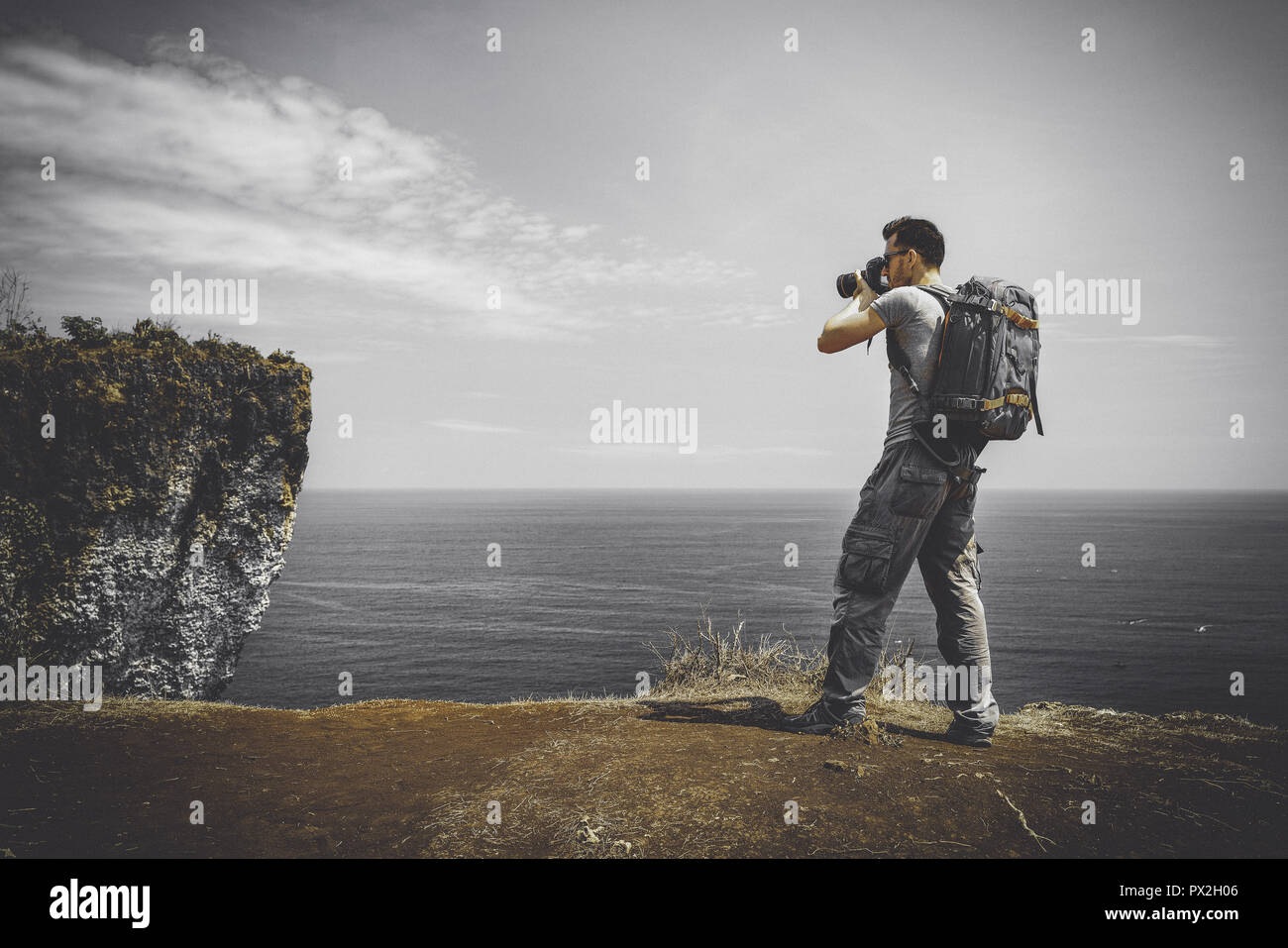 Travel photographer with backpack and camera in hand make photo outdoor ...