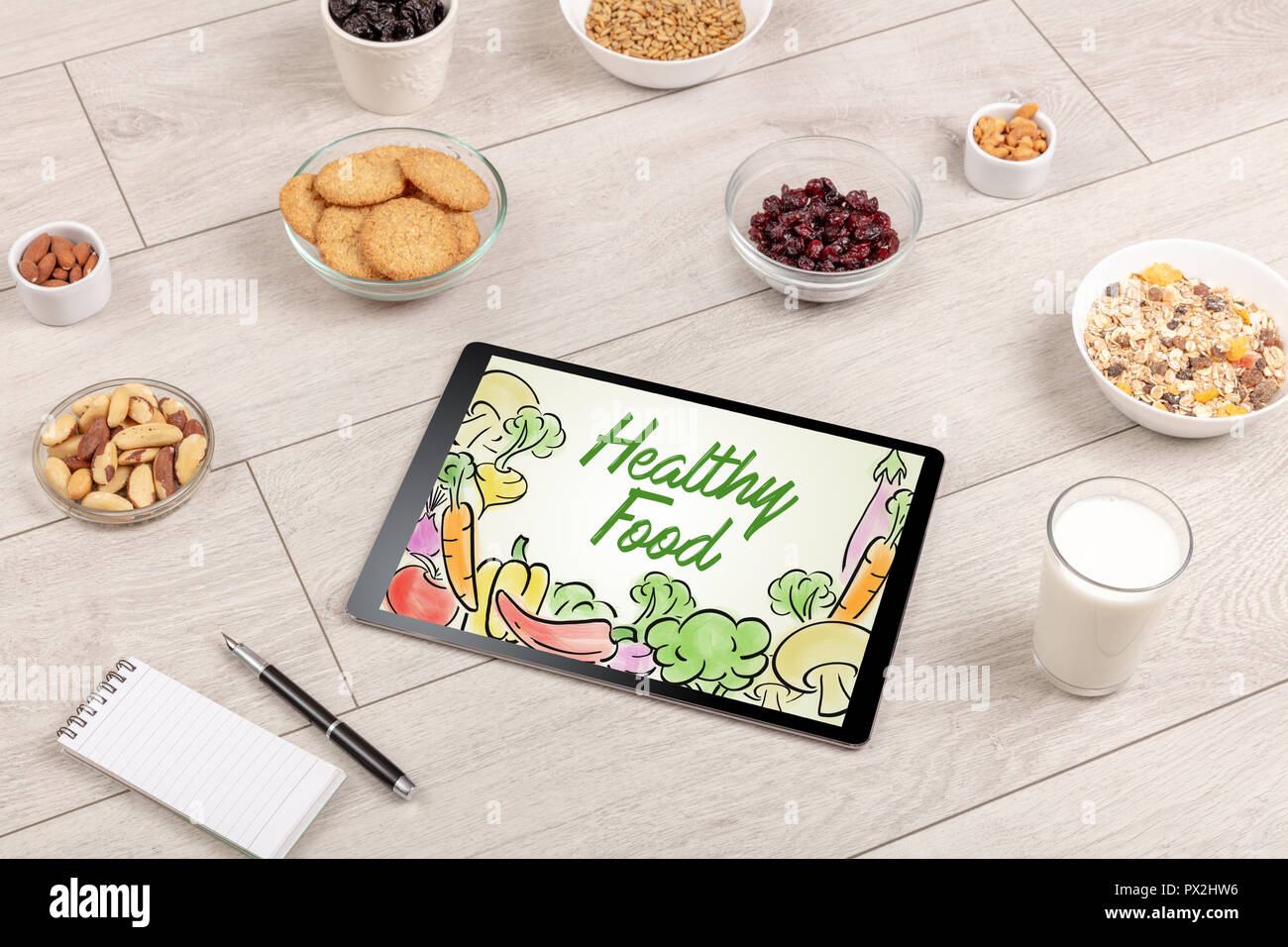 Healthy food composition with tablet Stock Photo - Alamy
