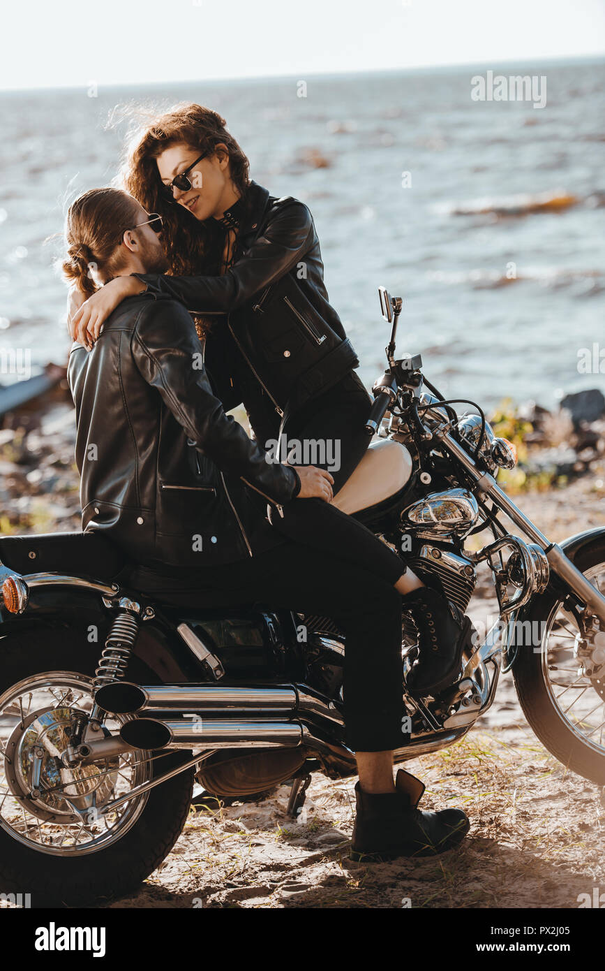 couple of bikers hugging on classical motorcycle on seashore Stock ...