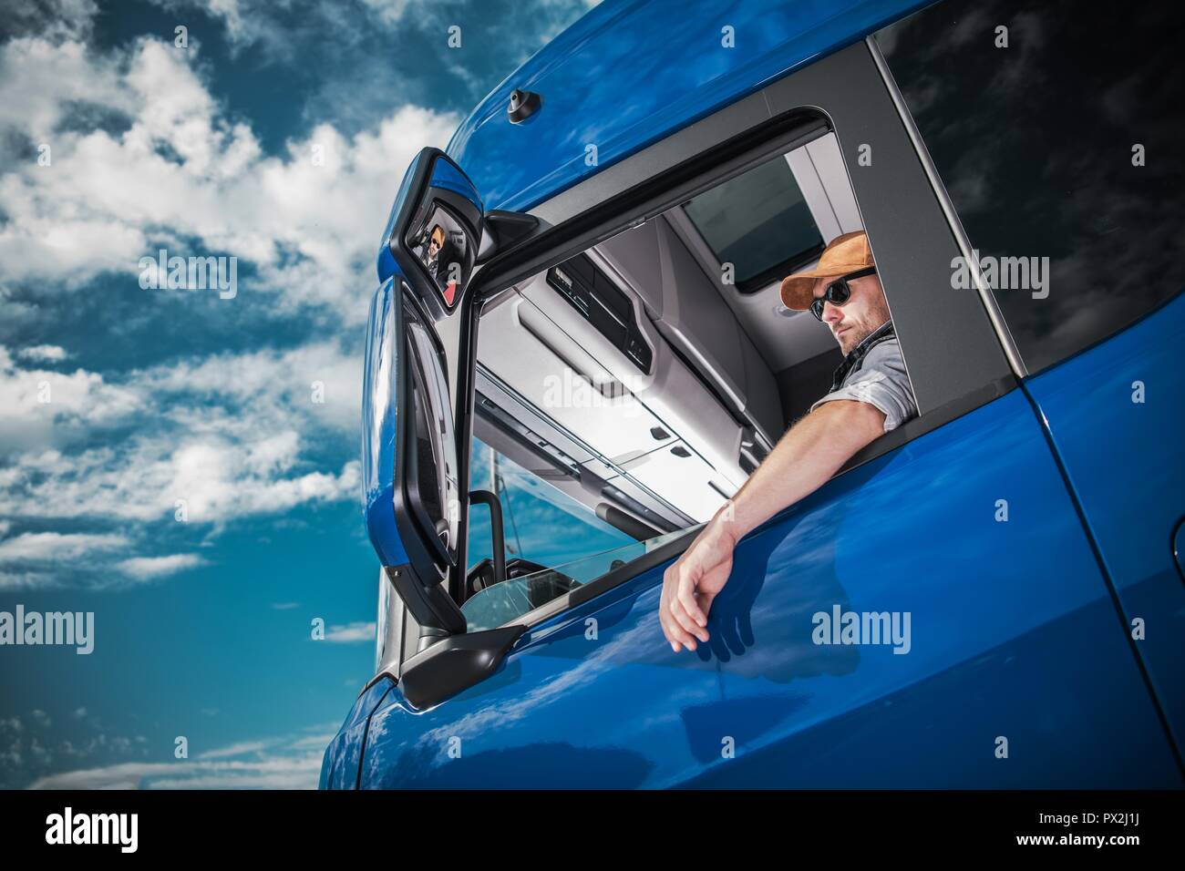 Heavy Load Cargo Delivery. Caucasian Truck Driver Inside Semi Tractor ...