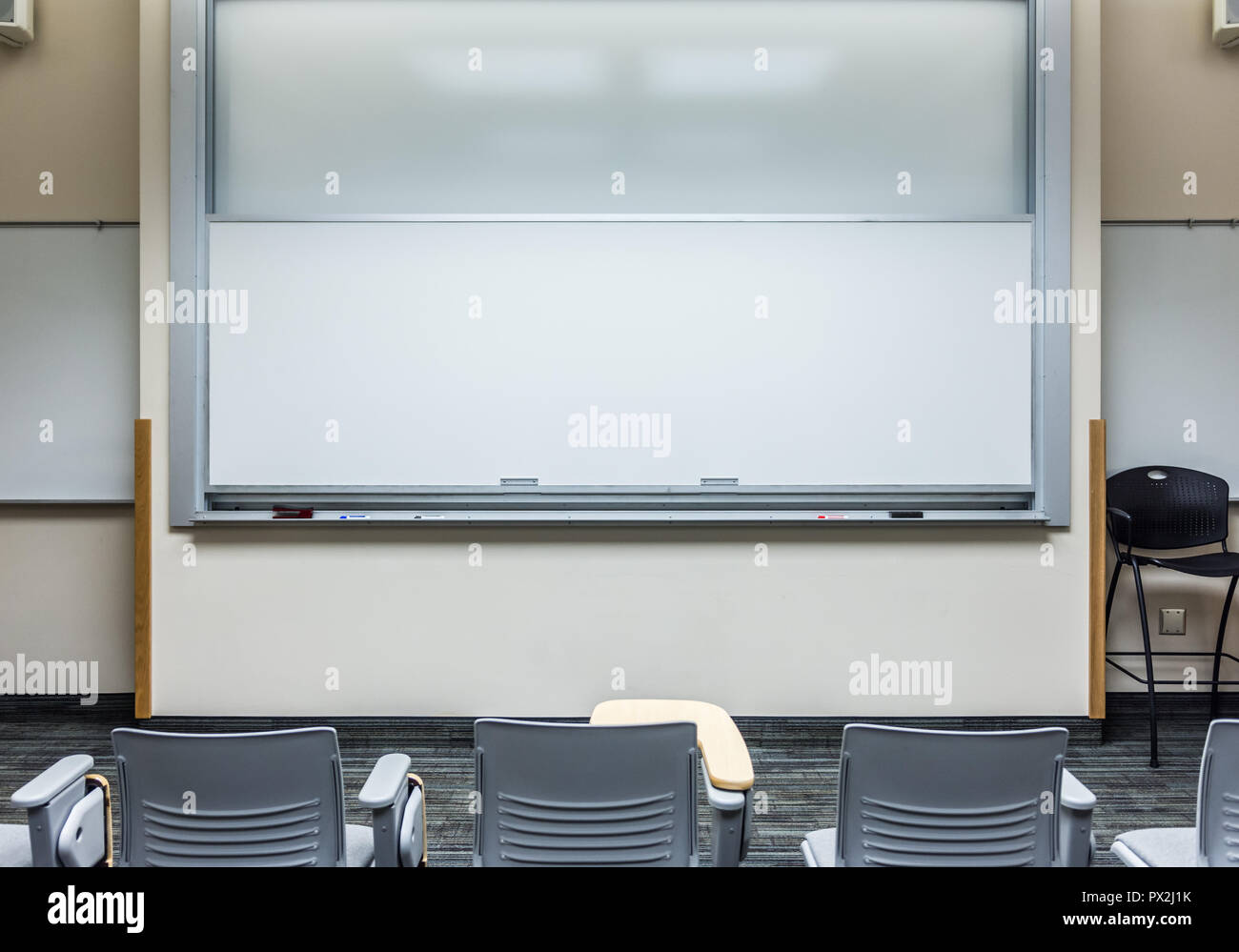 Well lit white board at from of modern lecture hall, conference room, university, college ...
