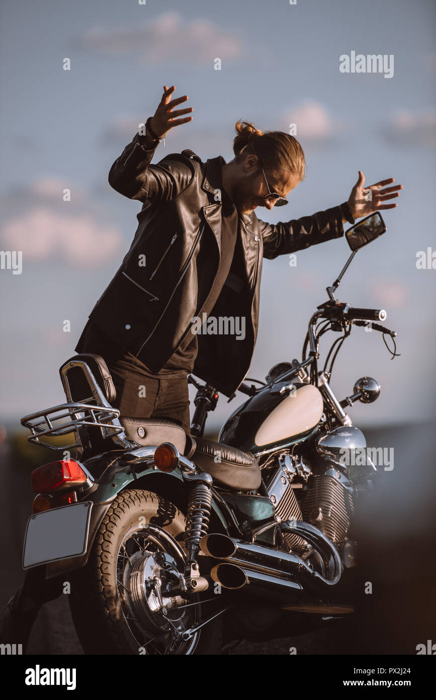 angry handsome man with broken motorcycle on road Stock Photo - Alamy