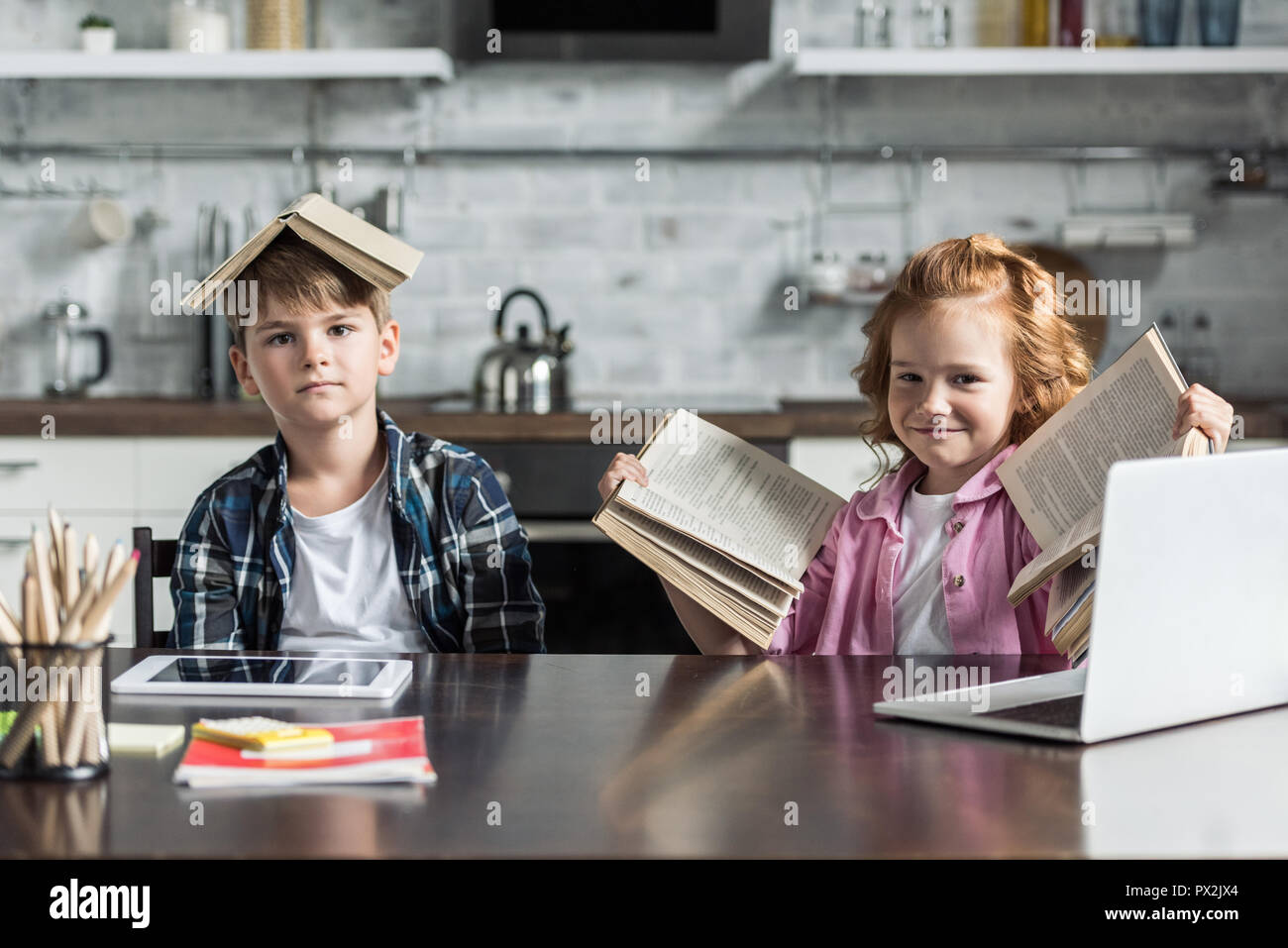 Kids looking at books High Resolution Stock Photography and Images - Alamy