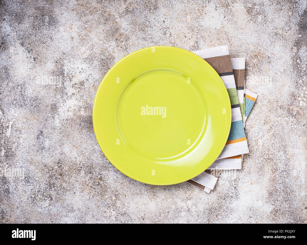 Empty green plate on concrete table Stock Photo - Alamy