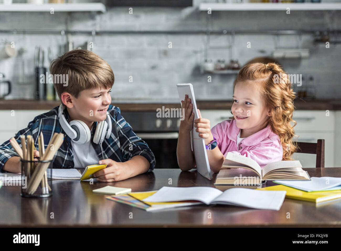 playful little kids doing homework together at kitchen Stock Photo - Alamy