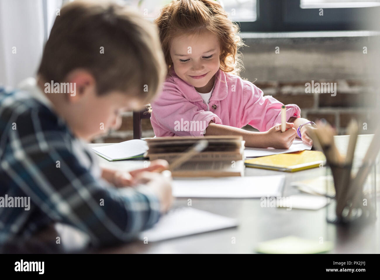 adorable little kids doing homework together Stock Photo - Alamy