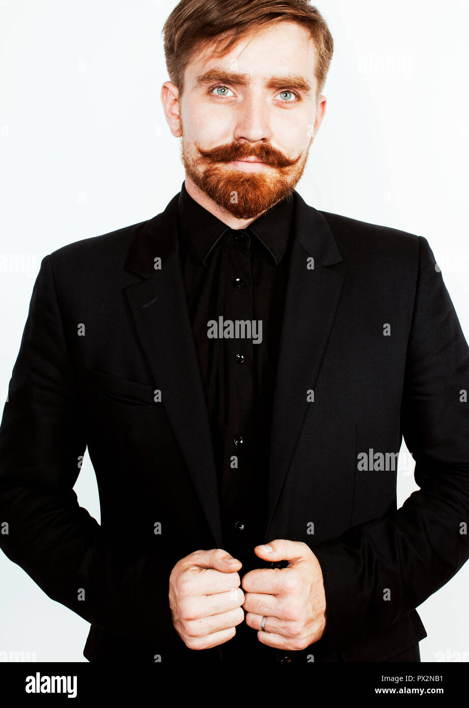 young red hair man with beard and mustache in black suit on whit Stock ...