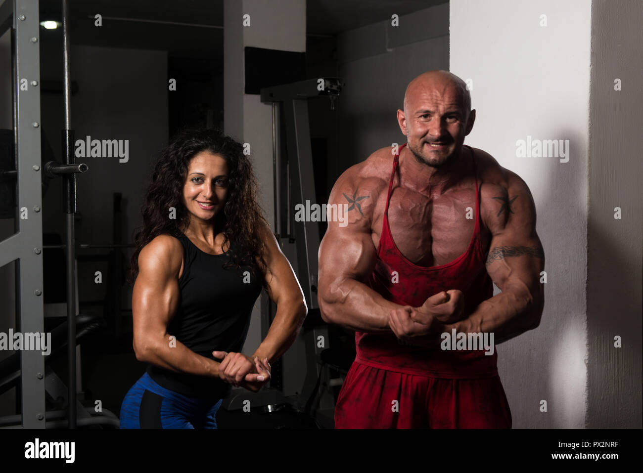 Awesome Bodybuilding Couple Showing Their Muscles And Posing In Gym ...