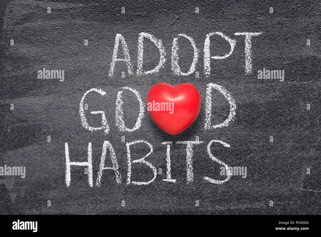 adopt good habits phrase handwritten on chalkboard with red heart ...