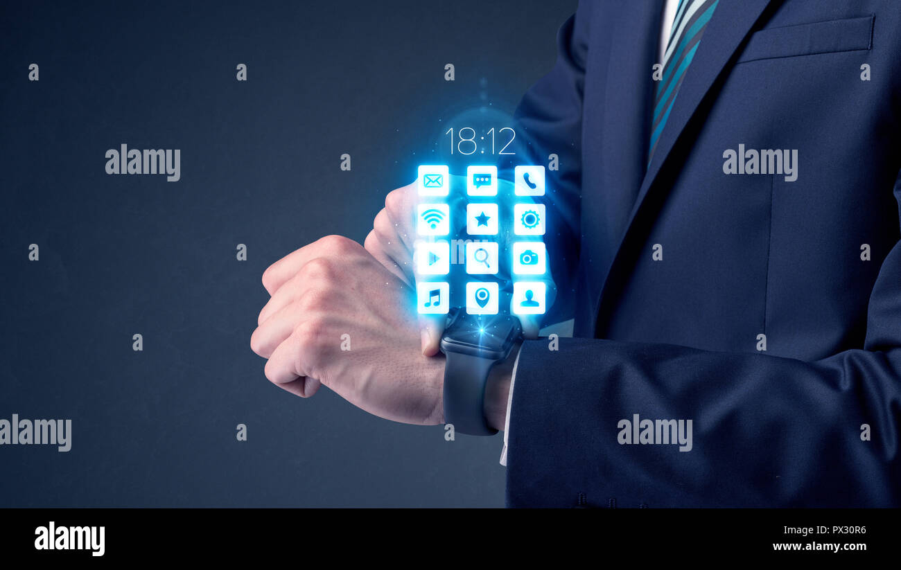 Businessman wearing smartwatch with application icons Stock Photo - Alamy