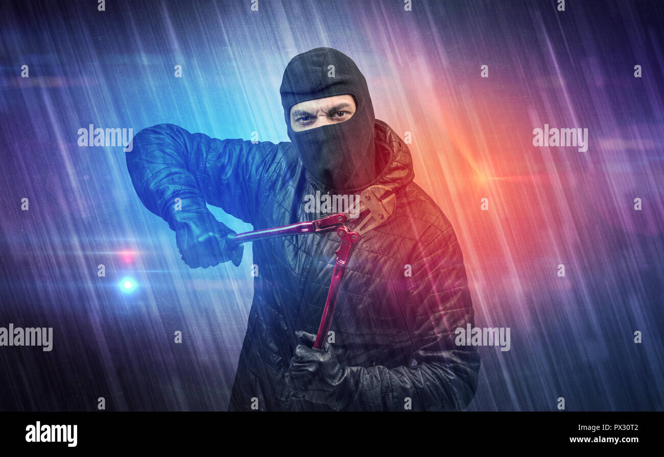 Burglar in action with colorful concept Stock Photo - Alamy