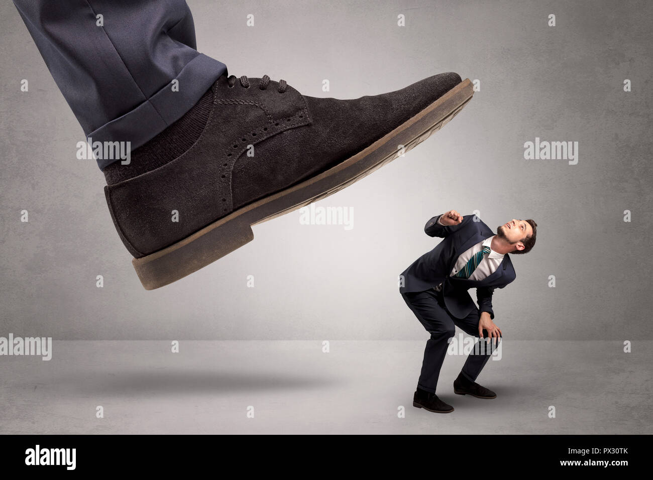 Young businessman illustrated inconsiderable by being trampled Stock ...