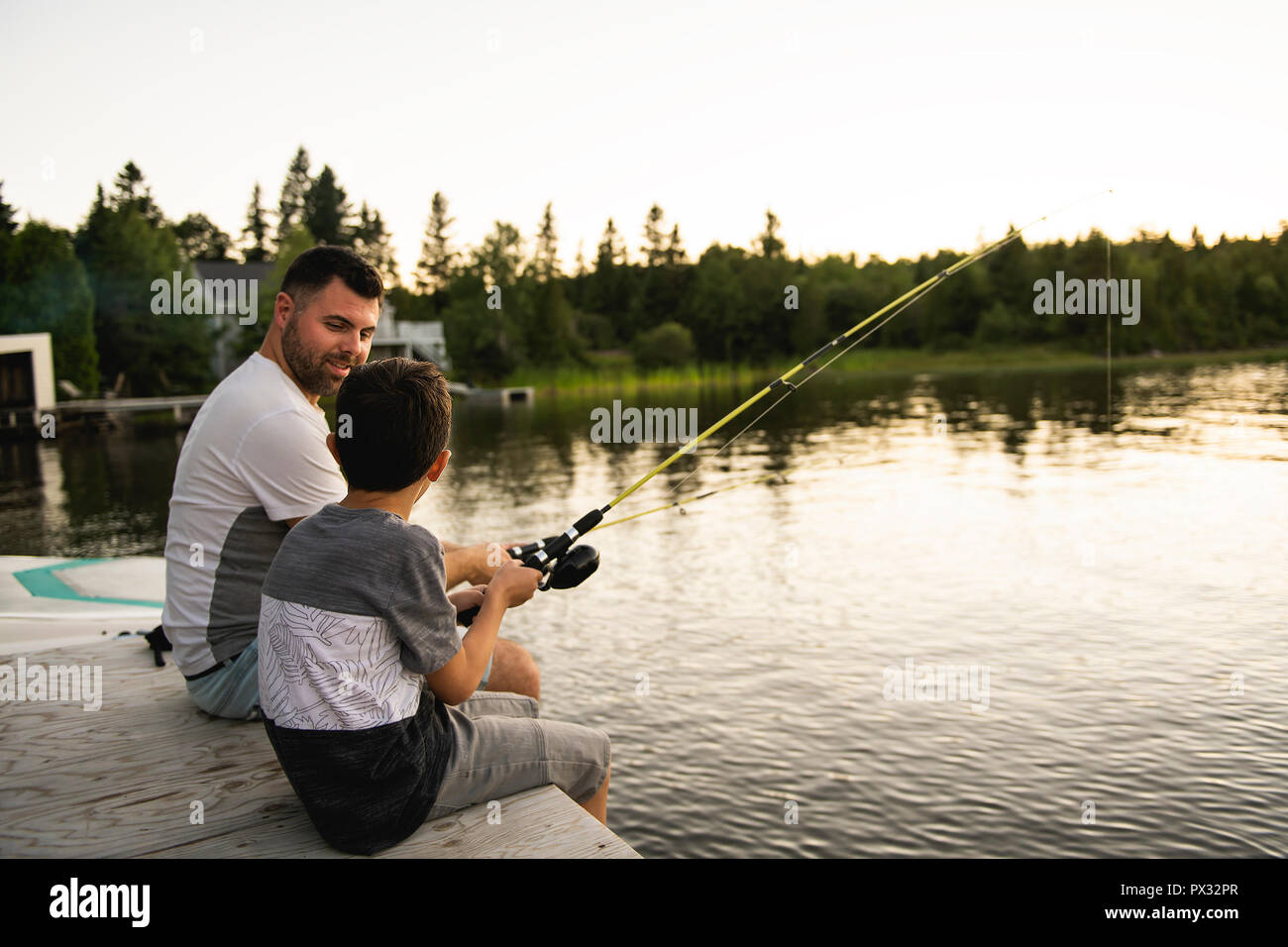 Cool Dad and son fishing on lake Stock Photo - Alamy