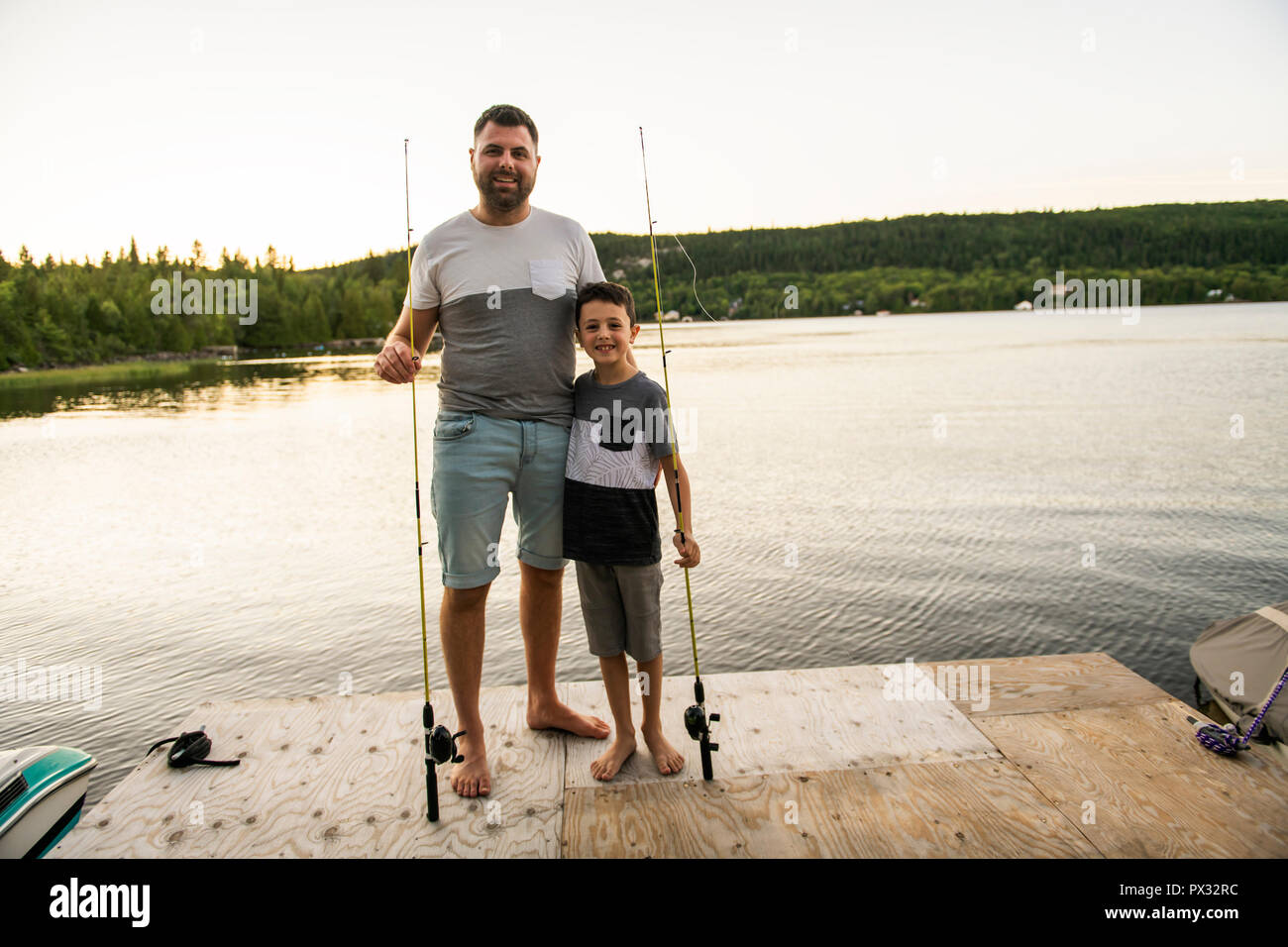 Cool Dad and son fishing on lake Stock Photo - Alamy